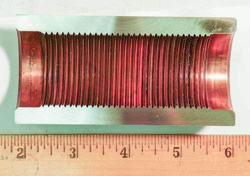 Sucker rod coupling material solves downhole wear economically